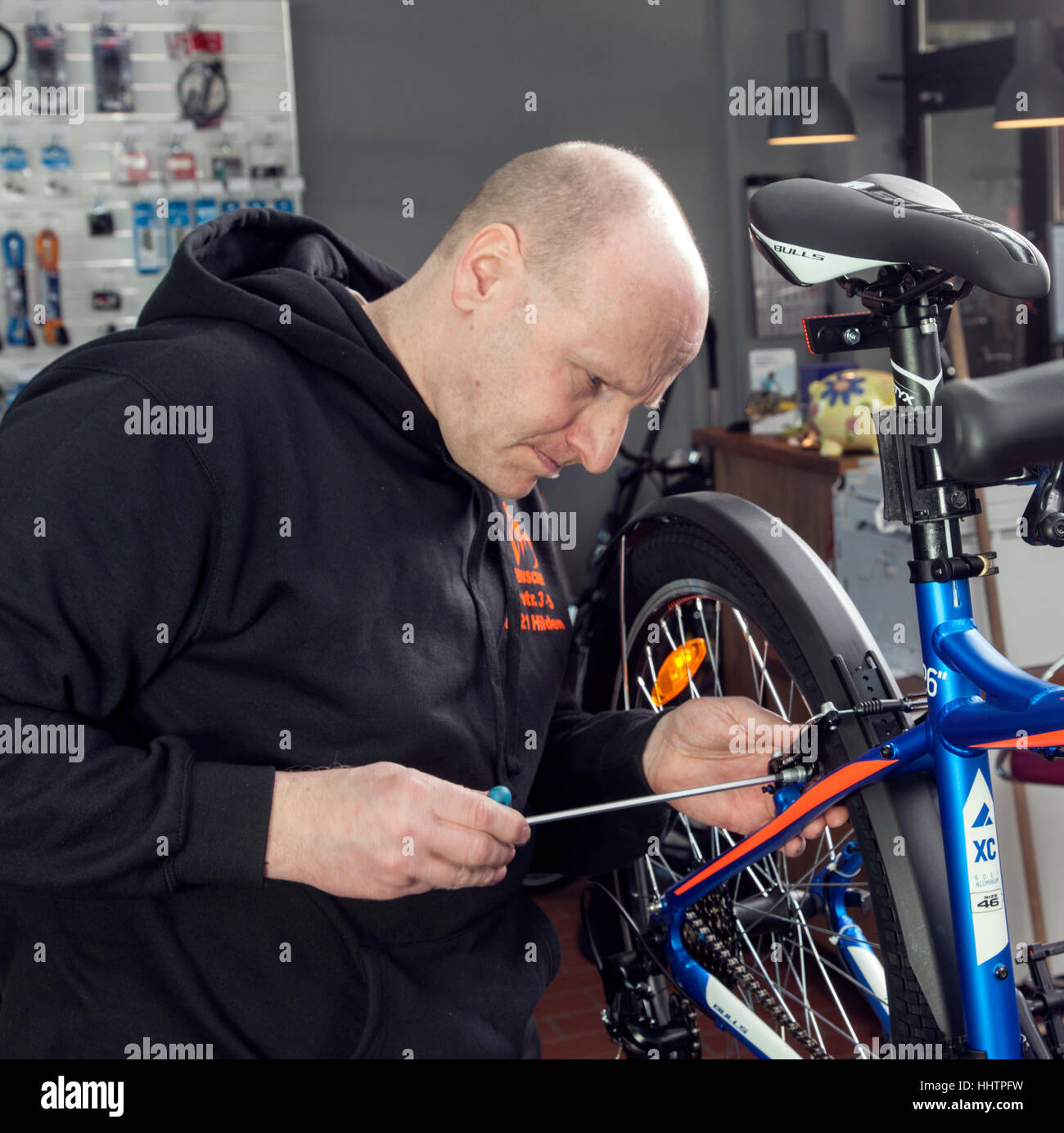 A bicycle mechanic during the inspection at a mountain bike in his ...