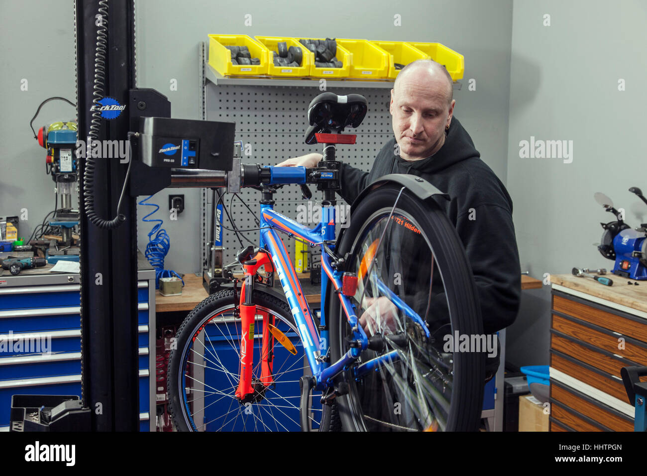 Bicycle mechanic during inspection mountain hi-res stock photography ...