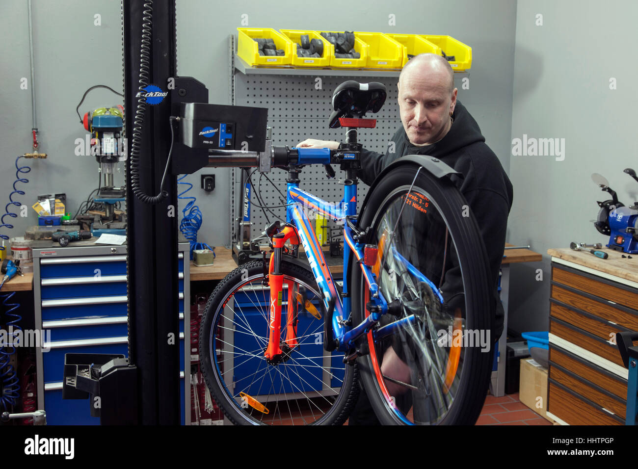 A bicycle mechanic during the inspection at a mountain bike in his ...