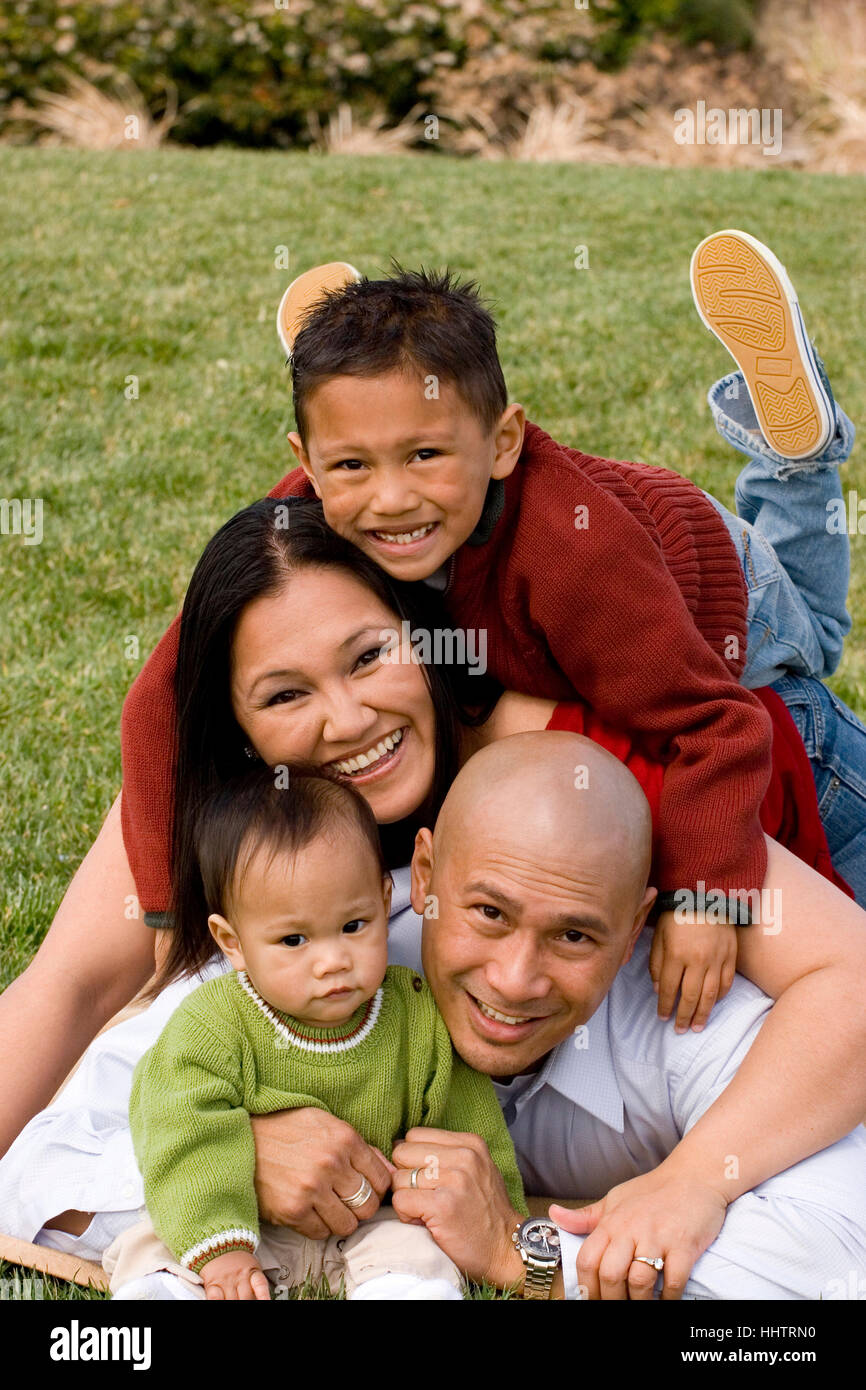 Loving Asain parents and their smiling children Stock Photo - Alamy
