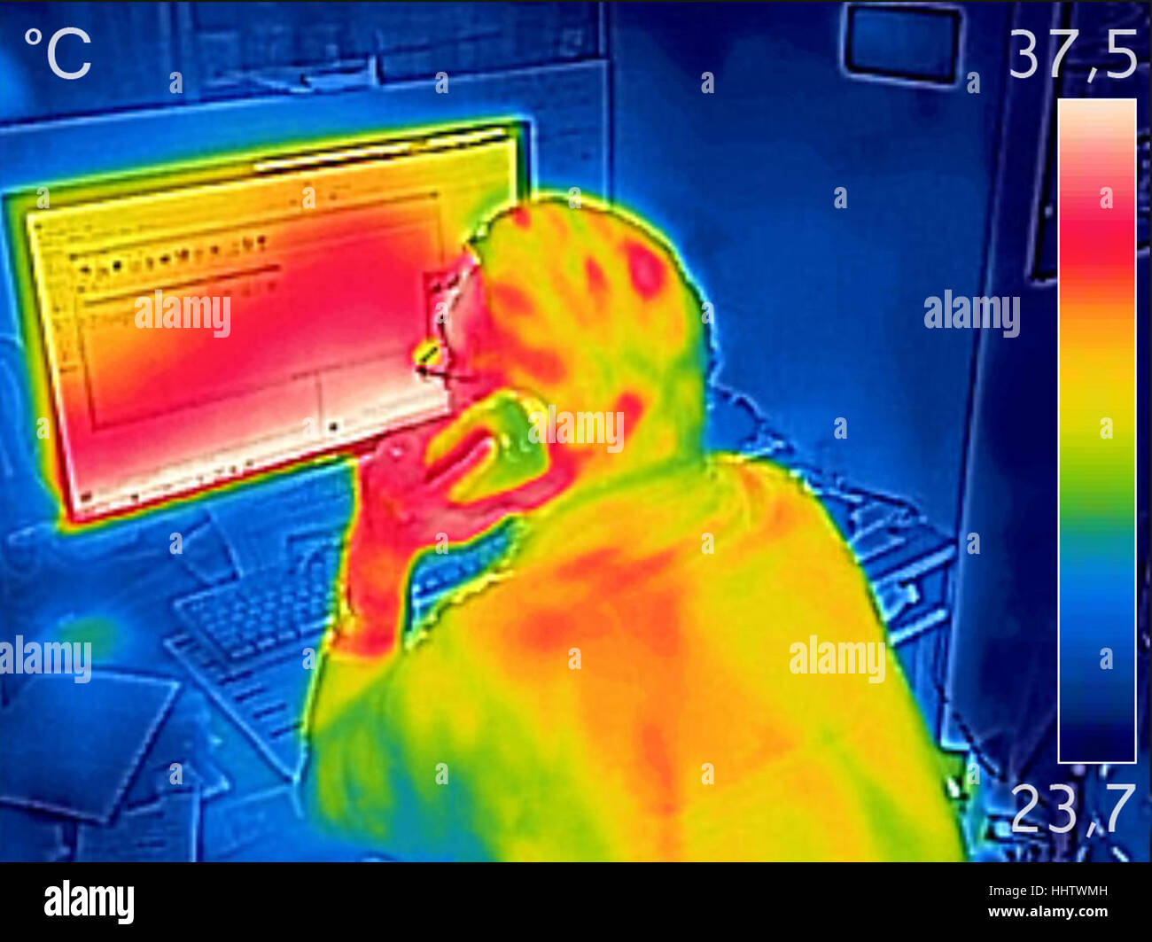 Infrared thermal image showing the heat emission while a man working on ...