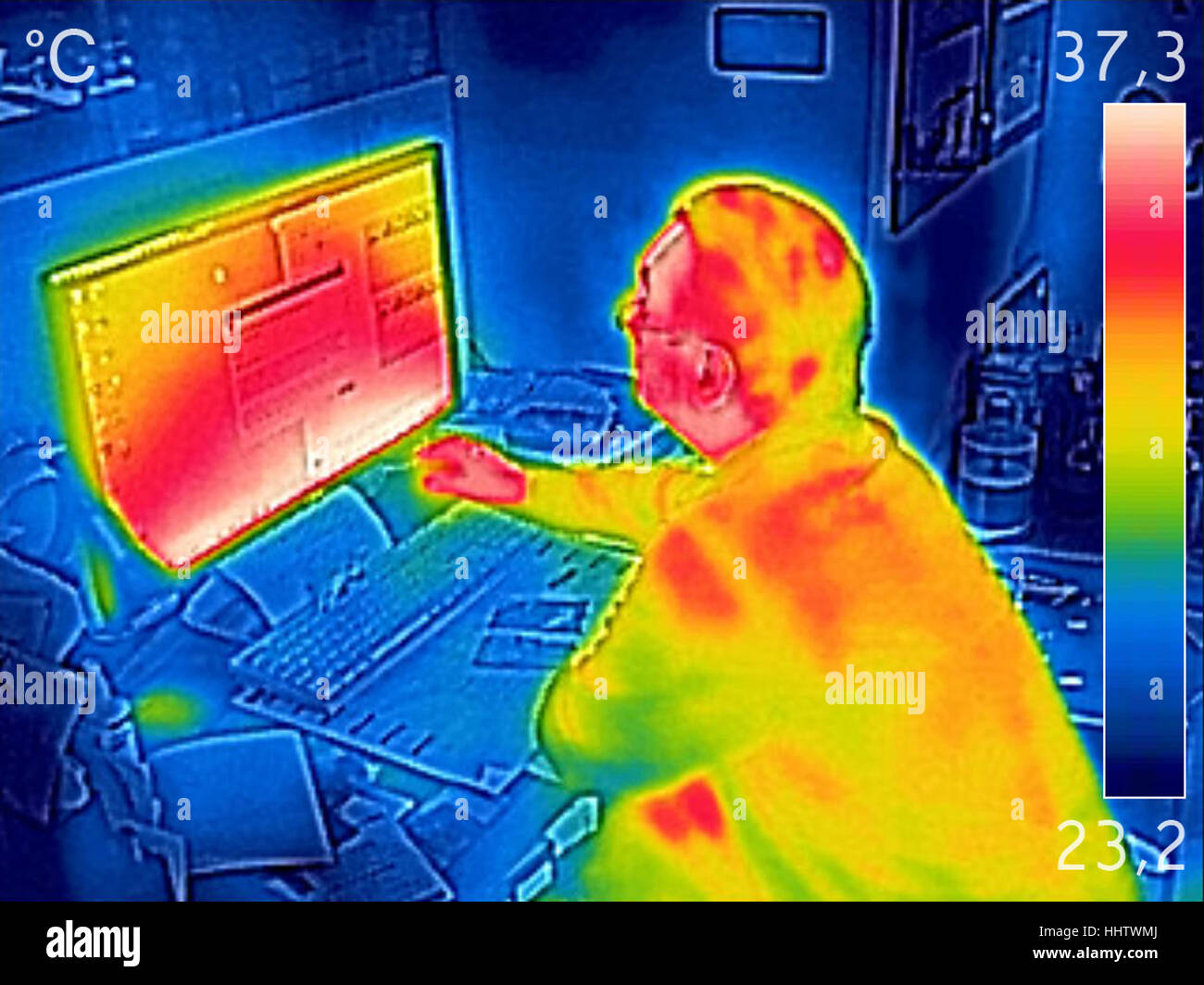 Infrared thermal image showing the heat emission while a man working on ...
