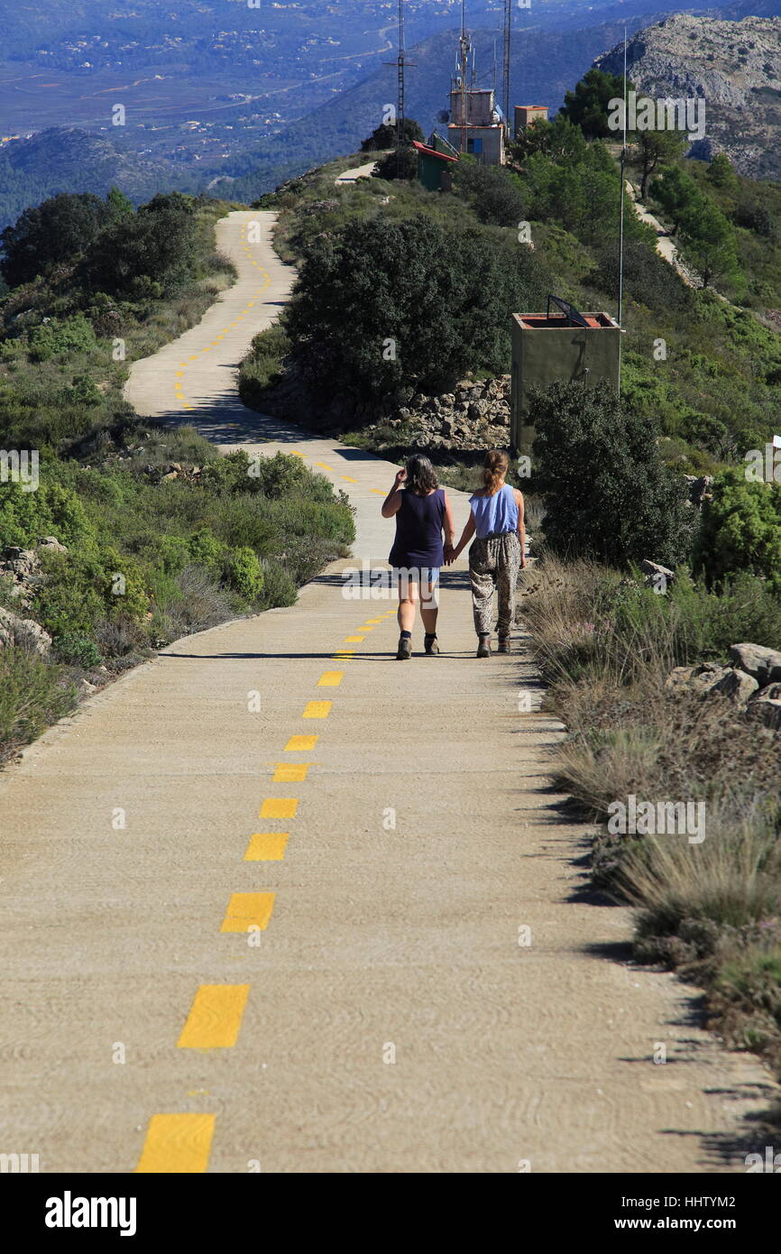 Two people on mountain path walk Coll de Rates, Tàrbena, Marina Alta ...