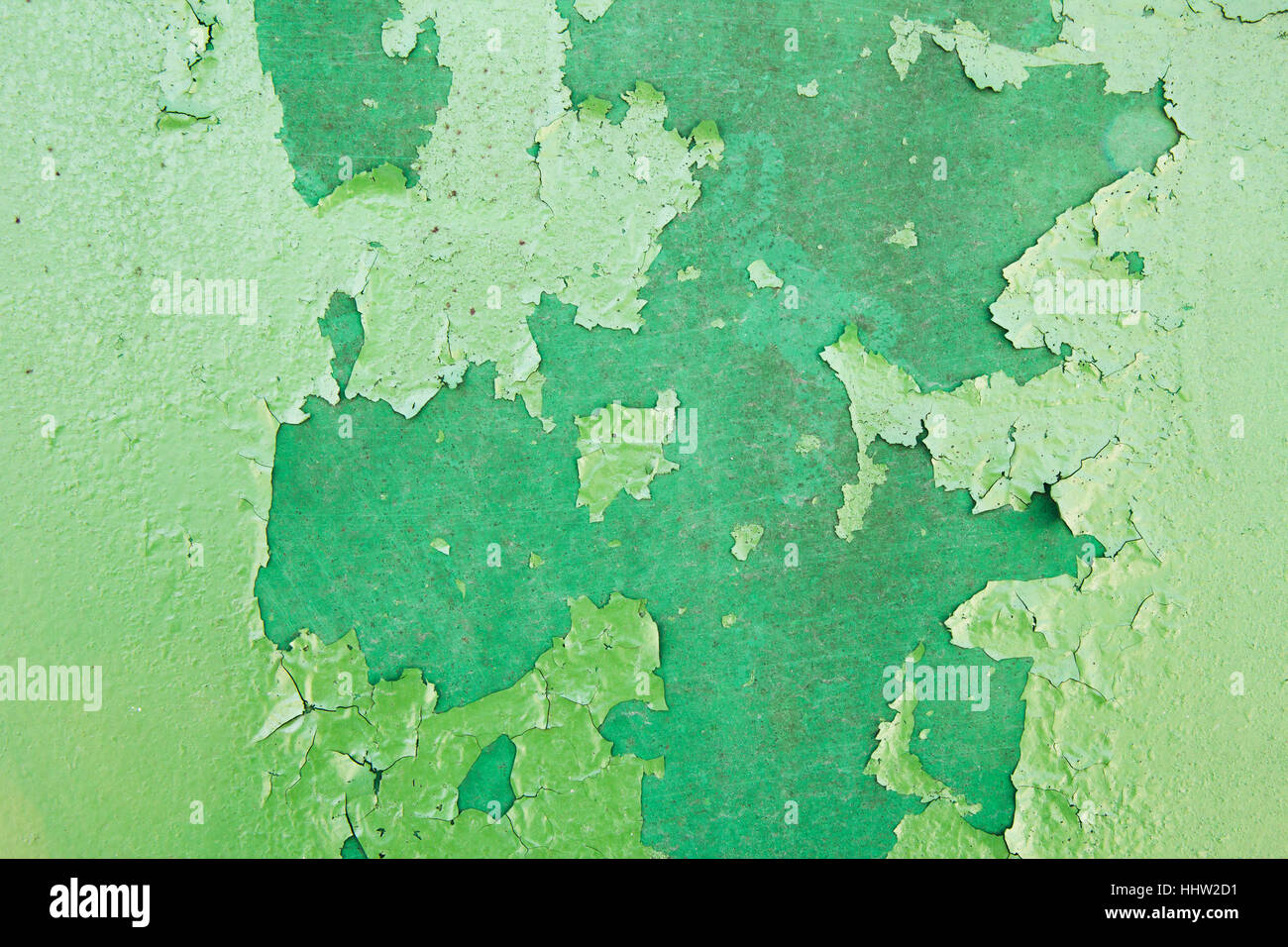 Green metal plate with cracked paint and big paint spots because of ...