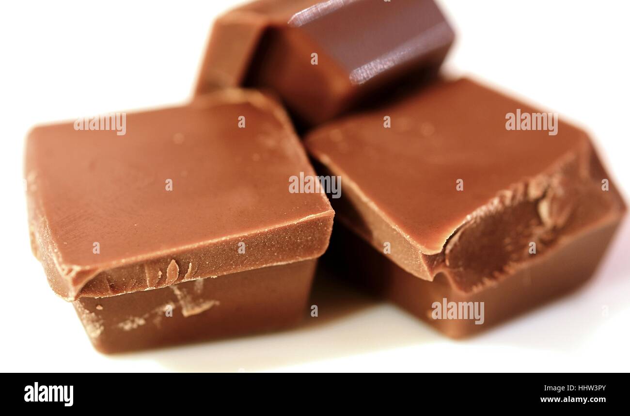 Macro shot of chocolate pieces on white background Stock Photo - Alamy