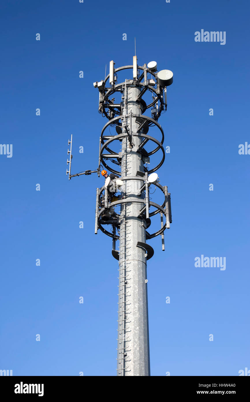 telecoms engineer repairing transmission mast Stock Photo - Alamy