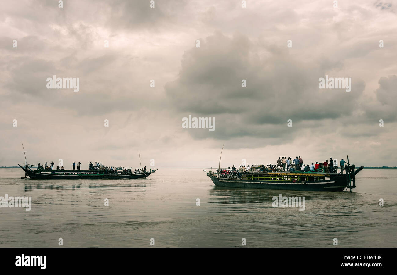 Overcrowded public ferries cross the flooded Brahmaputra river towards ...