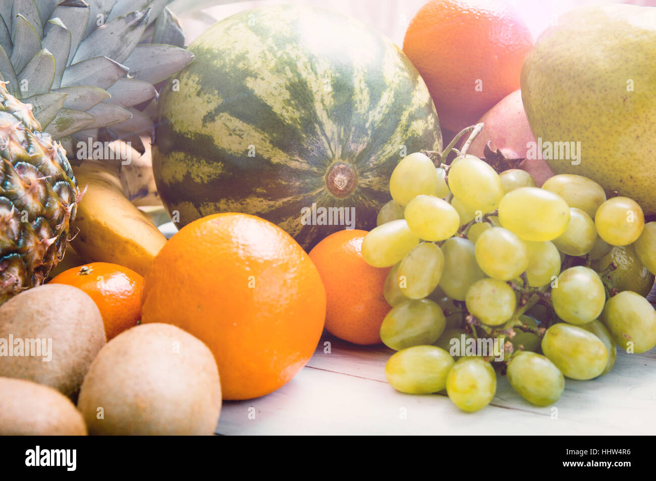 Stack of fruits on white wooden table Stock Photo - Alamy