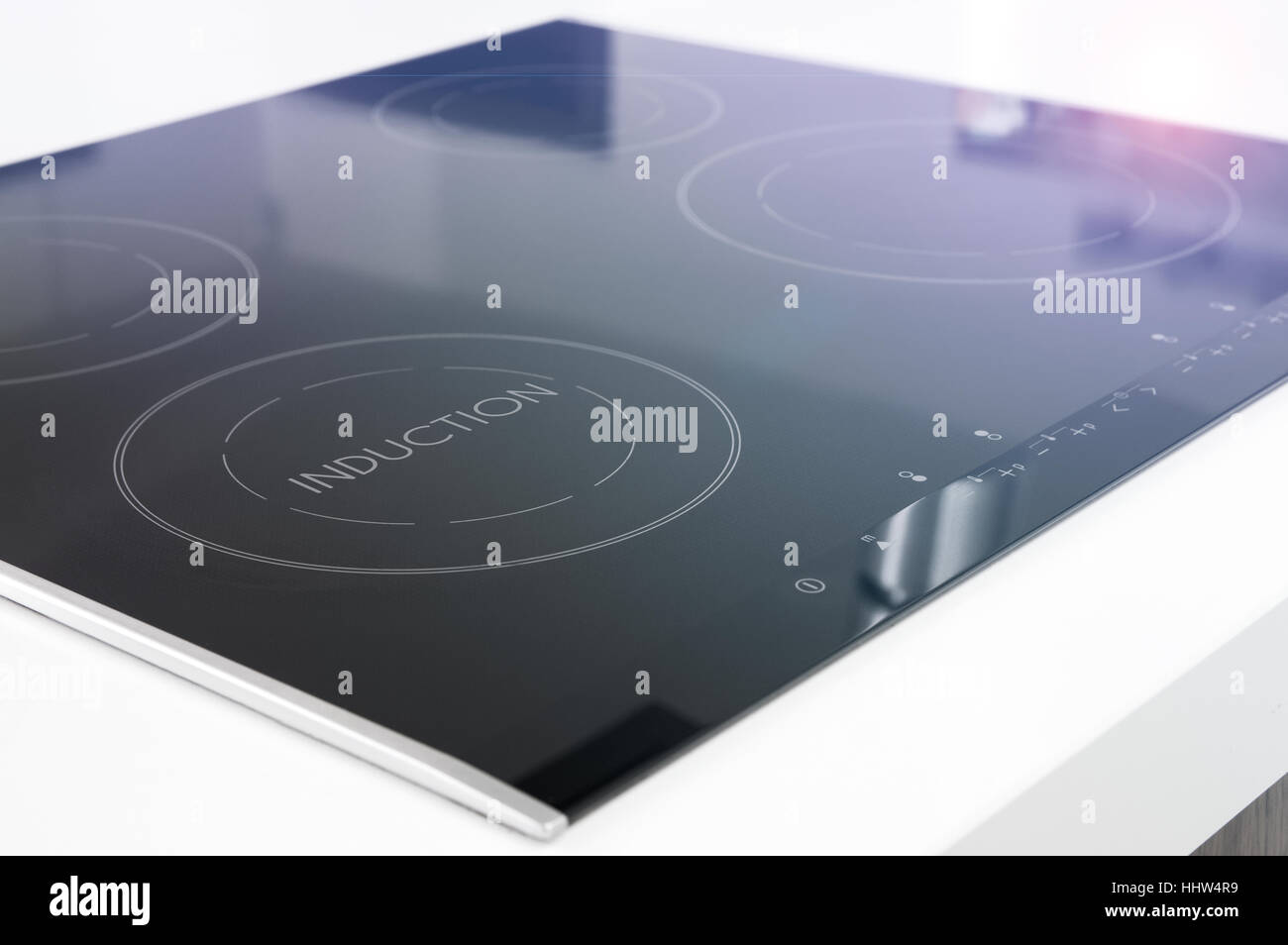 Modern black induction cooker on white countertop Stock Photo - Alamy