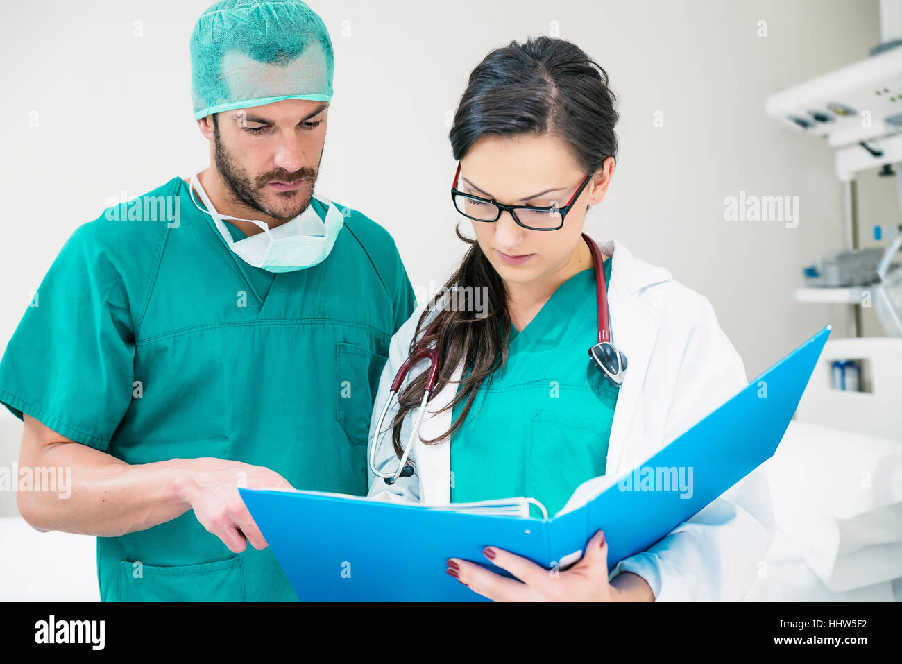Medical team workers examining a medical report in hospital room Stock ...