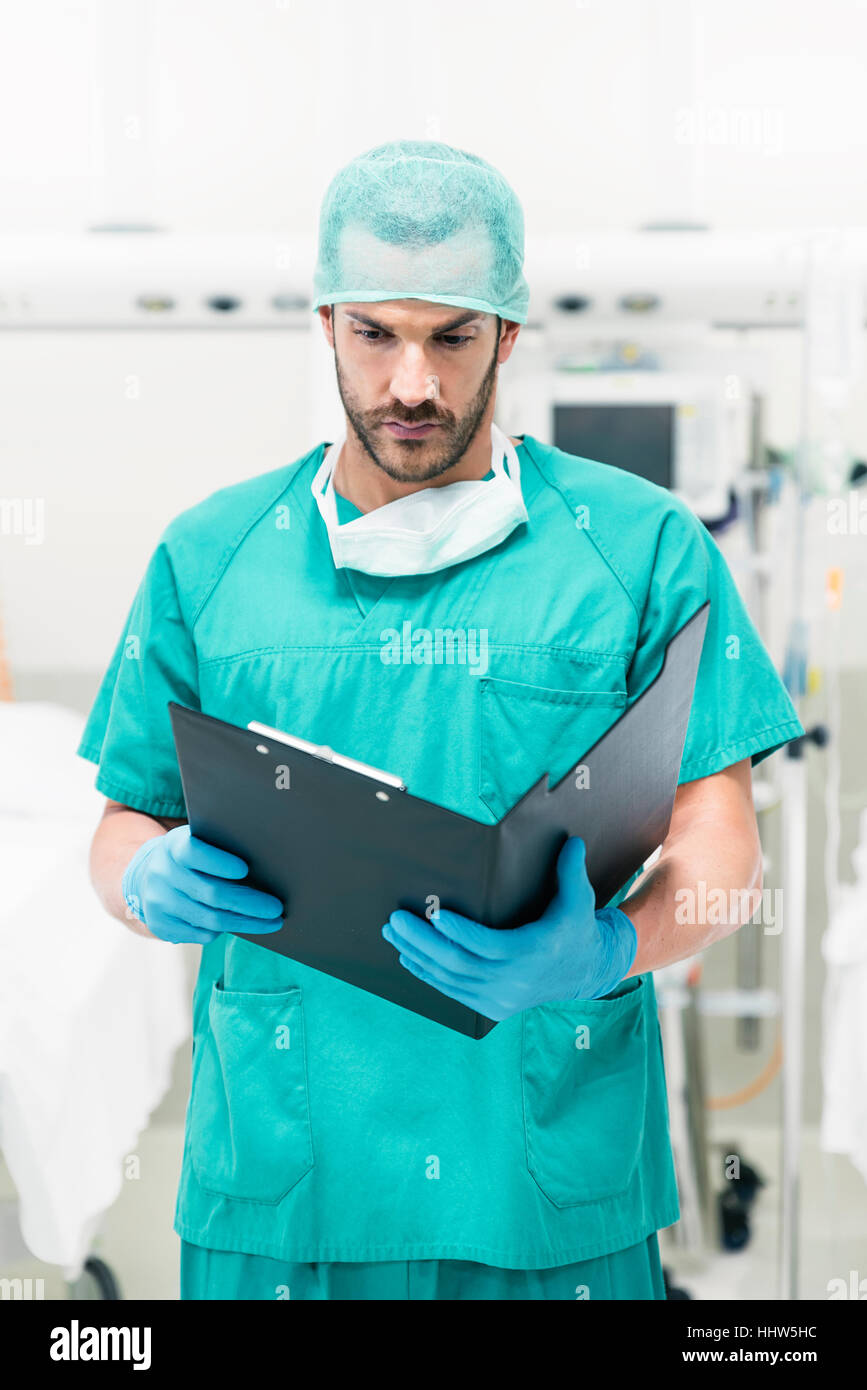Medical nurse worker examining a medical report in hospital room Stock ...