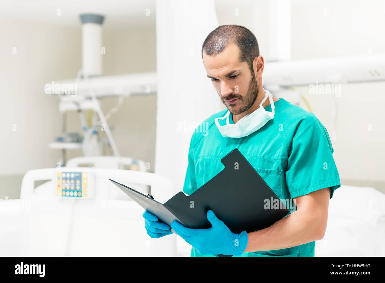 Medical nurse worker examining a medical report in hospital room Stock ...