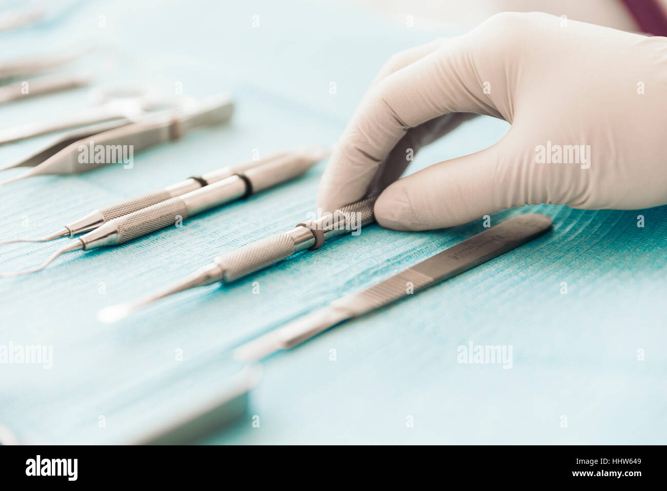 Detail of hand holding dental tools in dental clinic. Dentist Concept ...