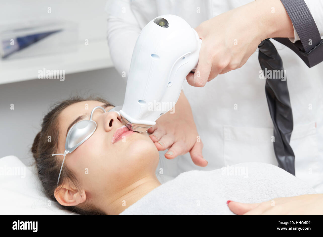 woman at cosmetics salon, legs underarm mustache laser epilation Stock ...