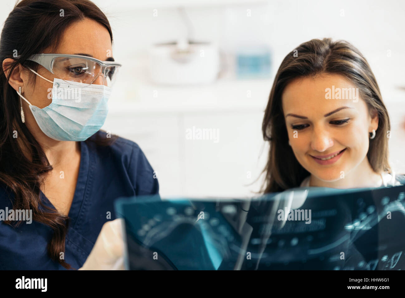 Doctor talking with her patient and teaching a radiograph. Medical ...