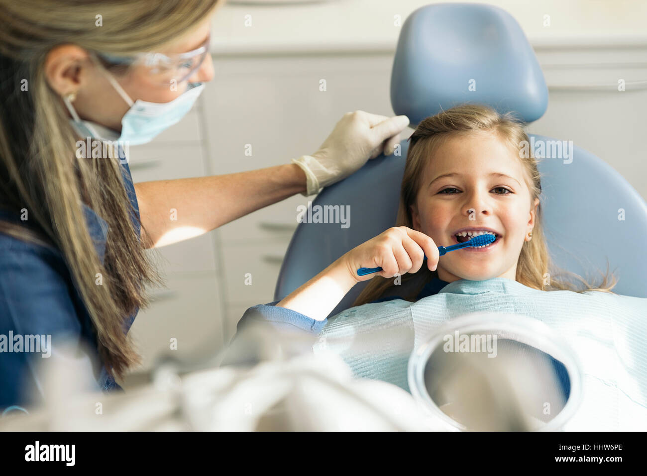 Doctor dentist teaching a child to brush teeth Stock Photo - Alamy