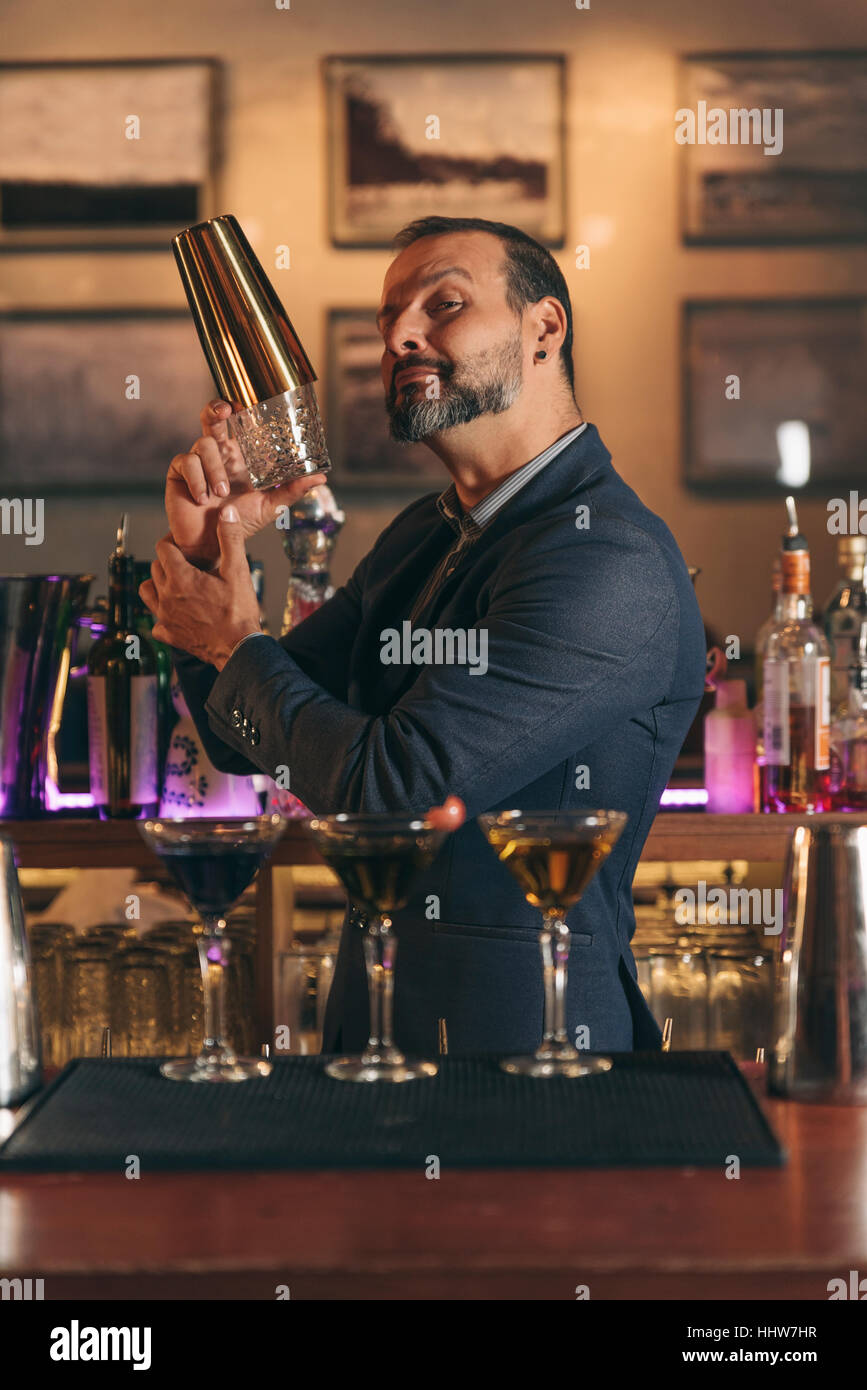 Expert barman is making cocktail at night club Stock Photo - Alamy