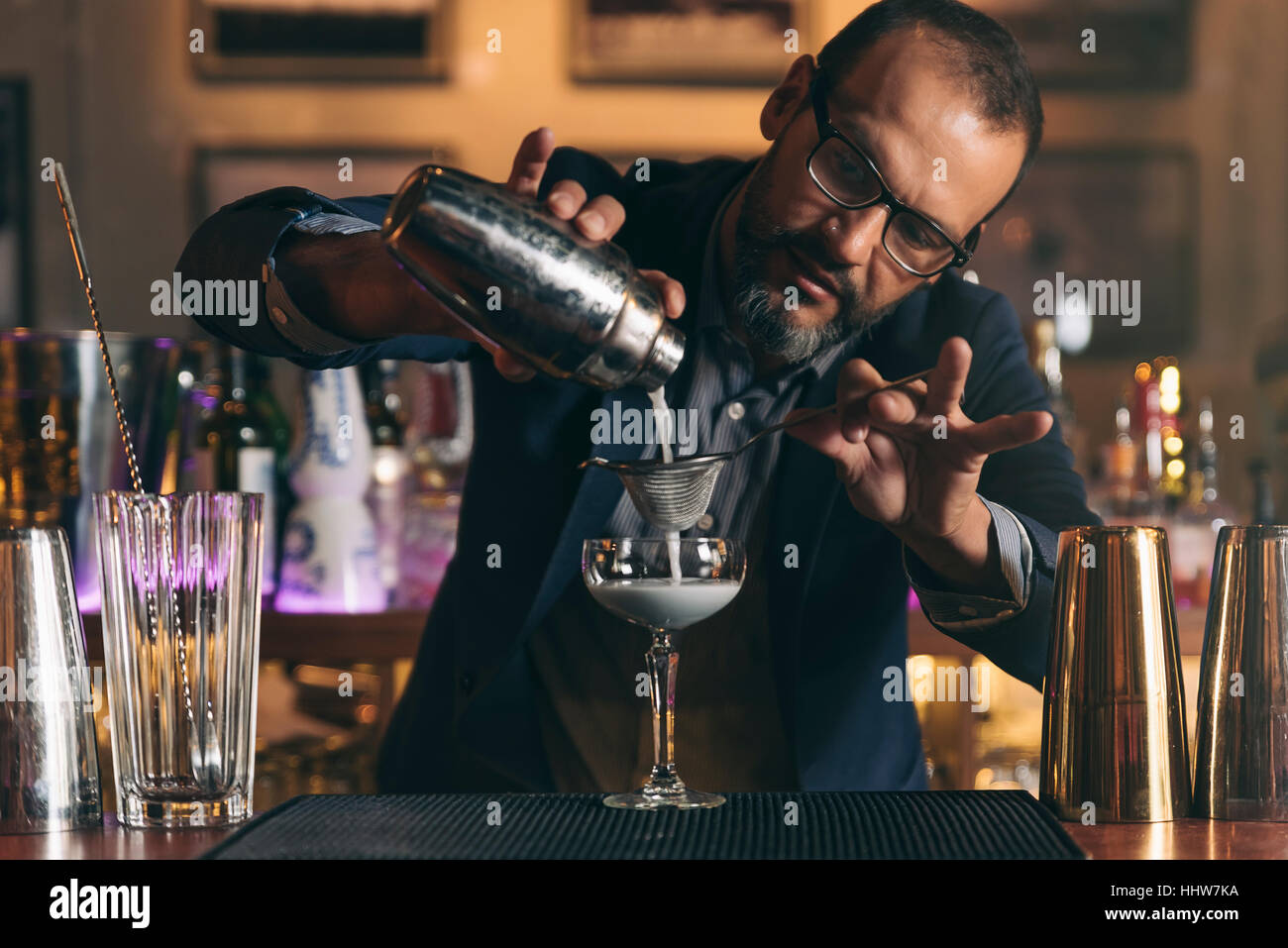 Expert barman is making cocktail at night club Stock Photo - Alamy