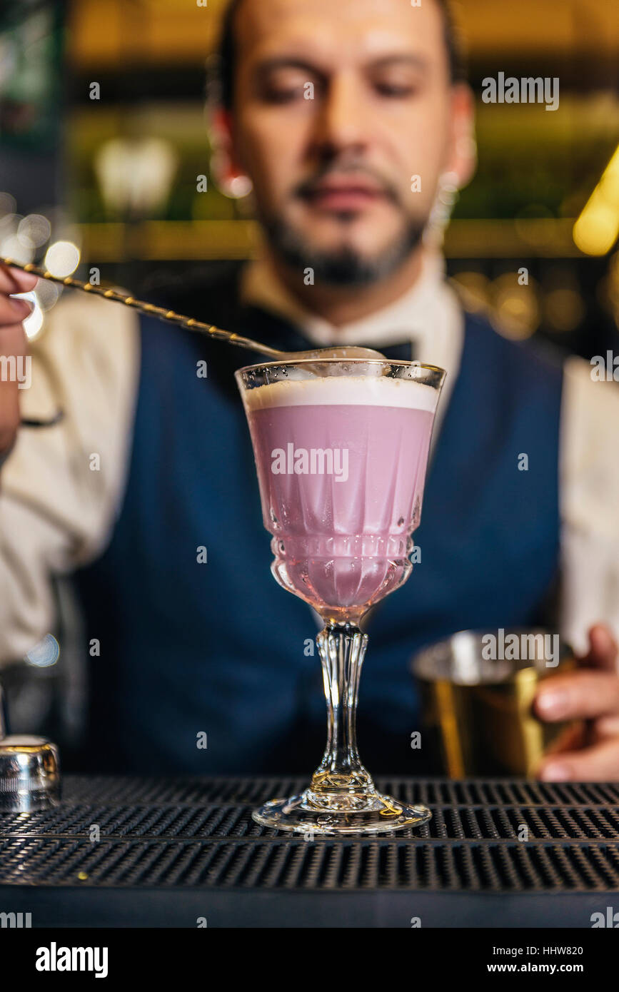 Expert barman is making cocktail at night club Stock Photo - Alamy