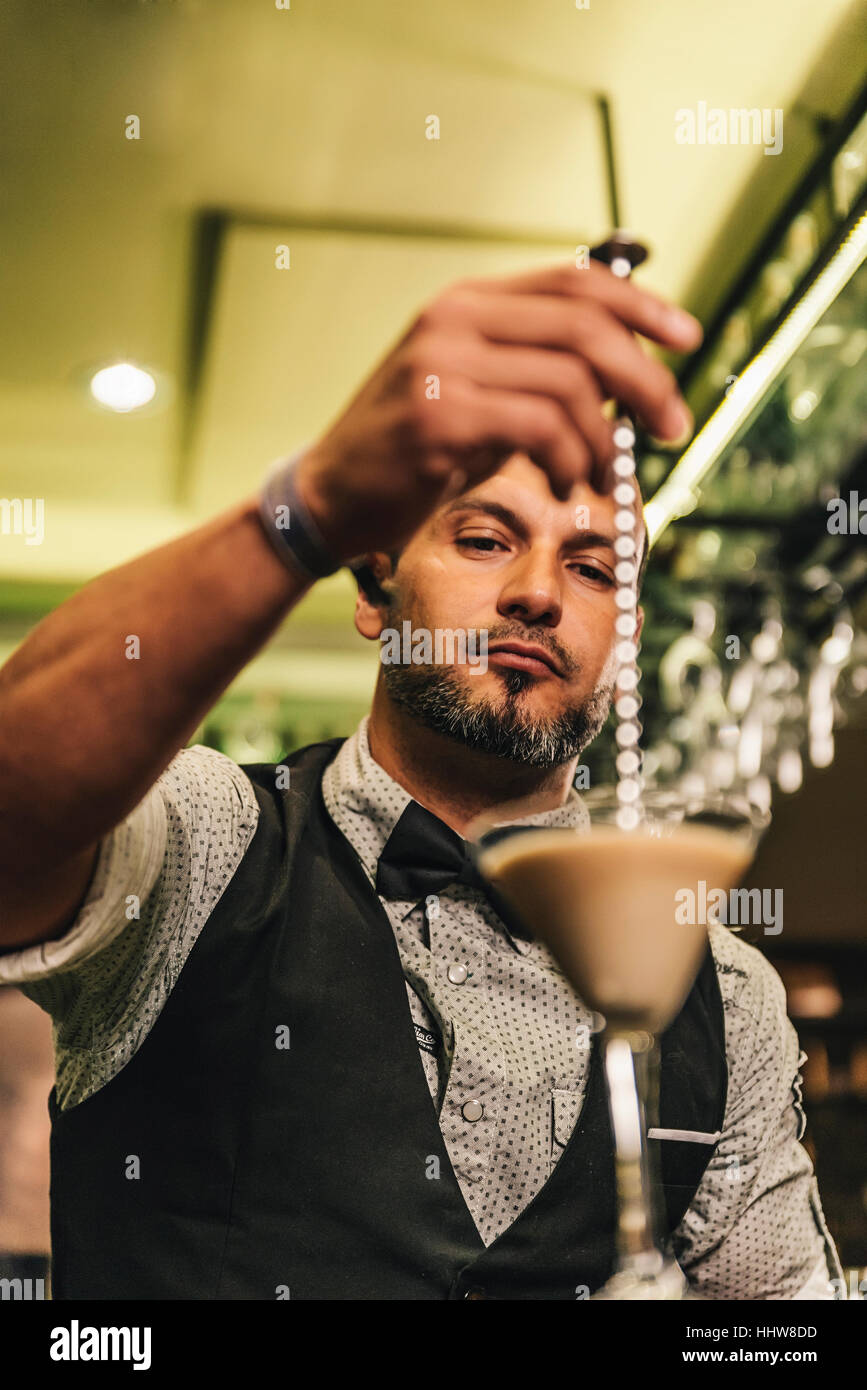 Expert barman is making cocktail at night club Stock Photo - Alamy