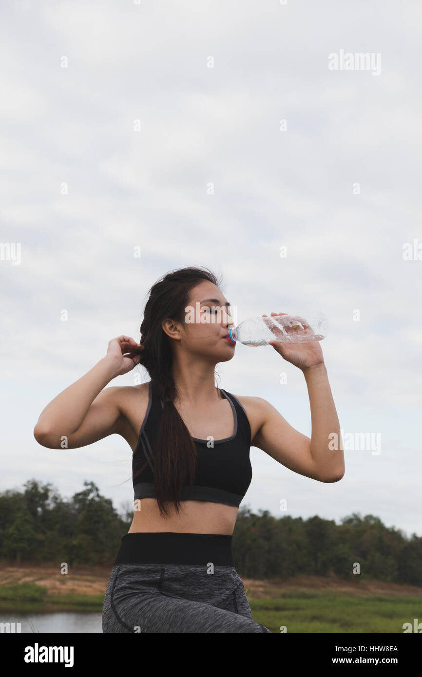 beautiful fitness athlete woman drinking water after workout exercising ...