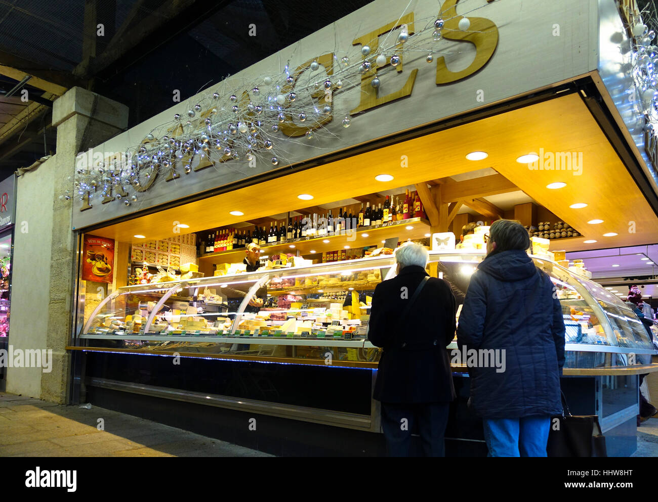 Cheese shop, cheese vendor, cheese store at the covered market Marché ...