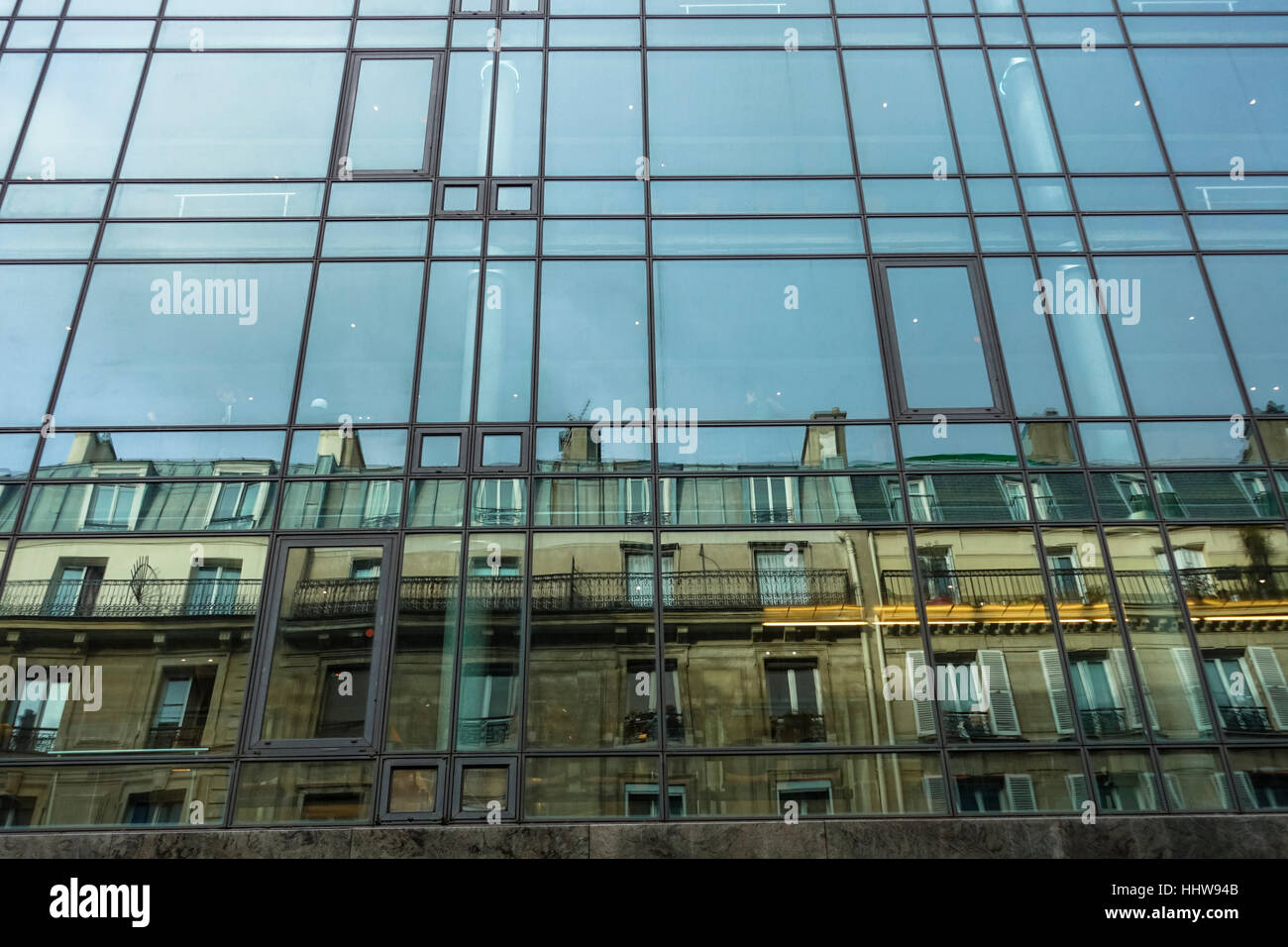 Haussmannian Parisian buildings reflecting in modern glass building ...