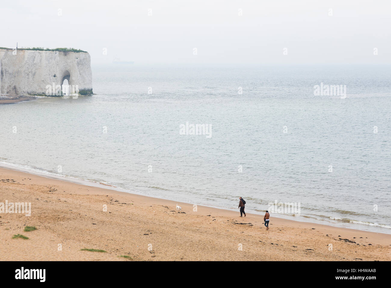 Kingsgate Bay, Margate, Kent. Couple walking their dog along the beach ...