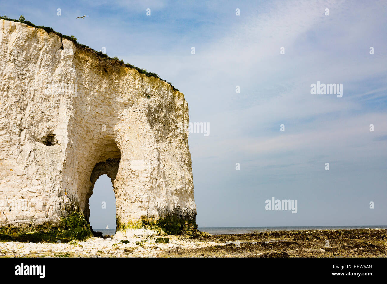 Kingsgate Bay, Margate, Kent. A sailing boat is framed by Kingsgate ...