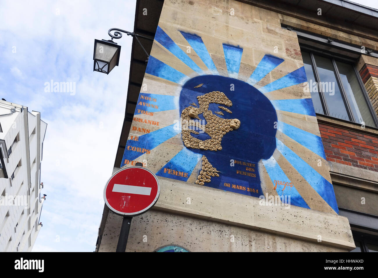 Street art, female face composed of small male heads, Grego street ...