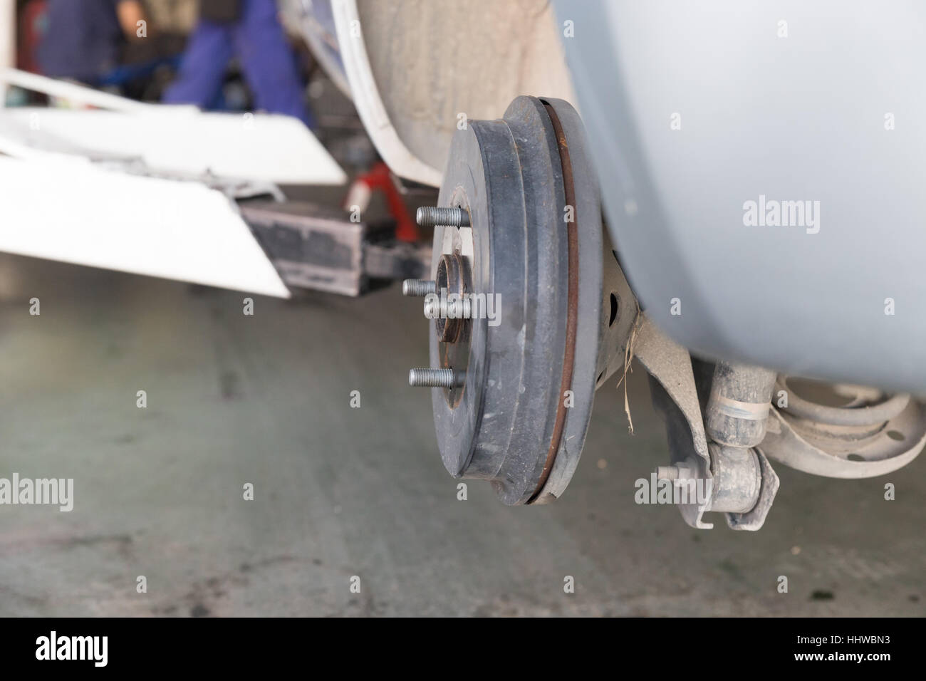 mechanic changing a wheel of a modern car, tire replacement service ...