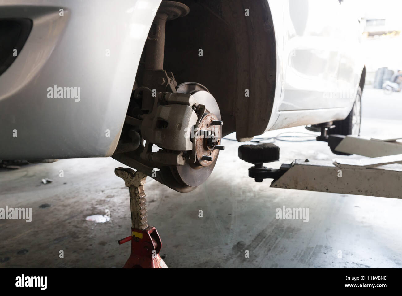 mechanic changing a wheel of a modern car, tire replacement service ...