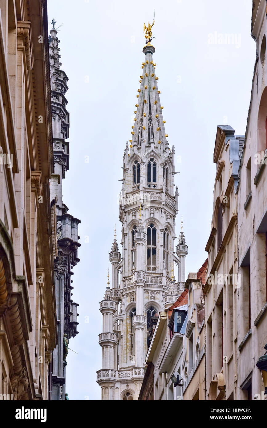 Tower of medieval city hall of Brussels visible from a narrow street ...