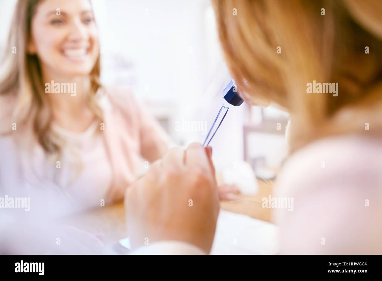 Jeweler helping woman shopping using loupe Stock Photo - Alamy