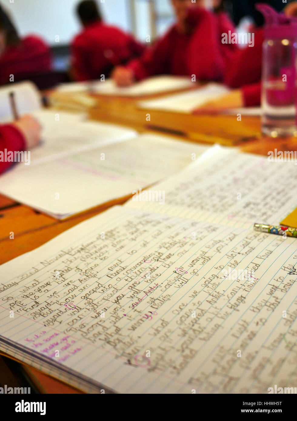 primary school children writing in an exercise book Stock Photo - Alamy