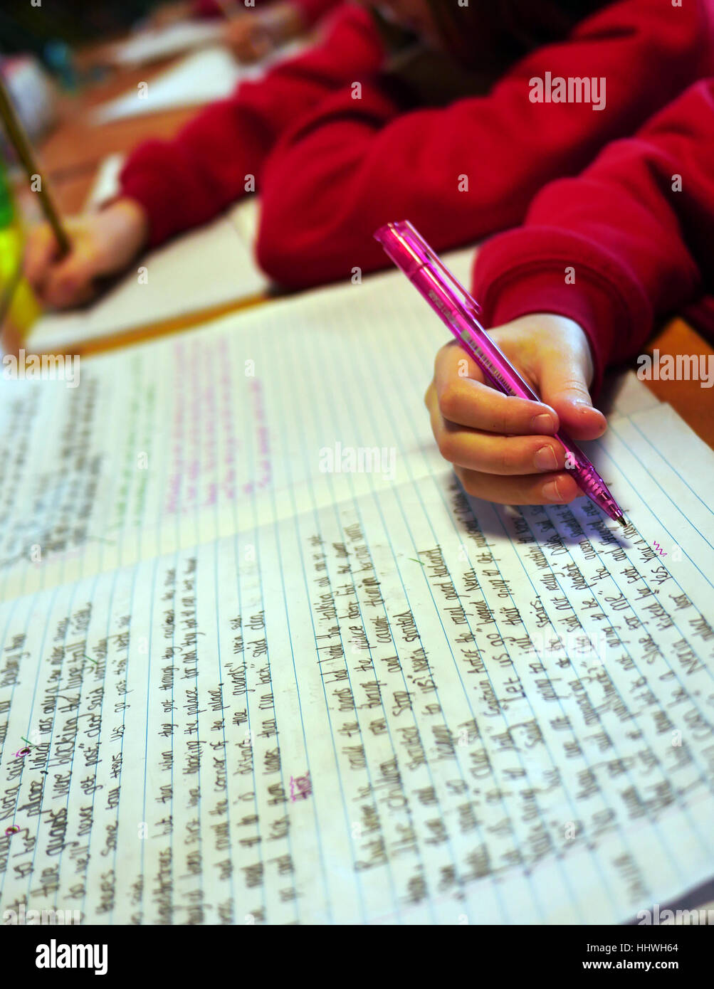 primary school children writing in an exercise book Stock Photo - Alamy