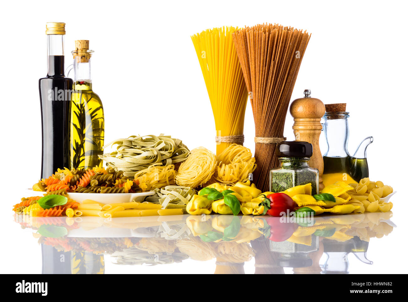 Different types of pasta and cooking ingredients isolated on white ...