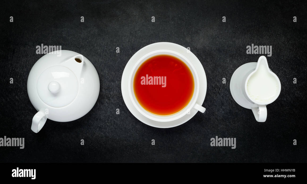White Teapot with Tea cup and Milk in top view Stock Photo - Alamy