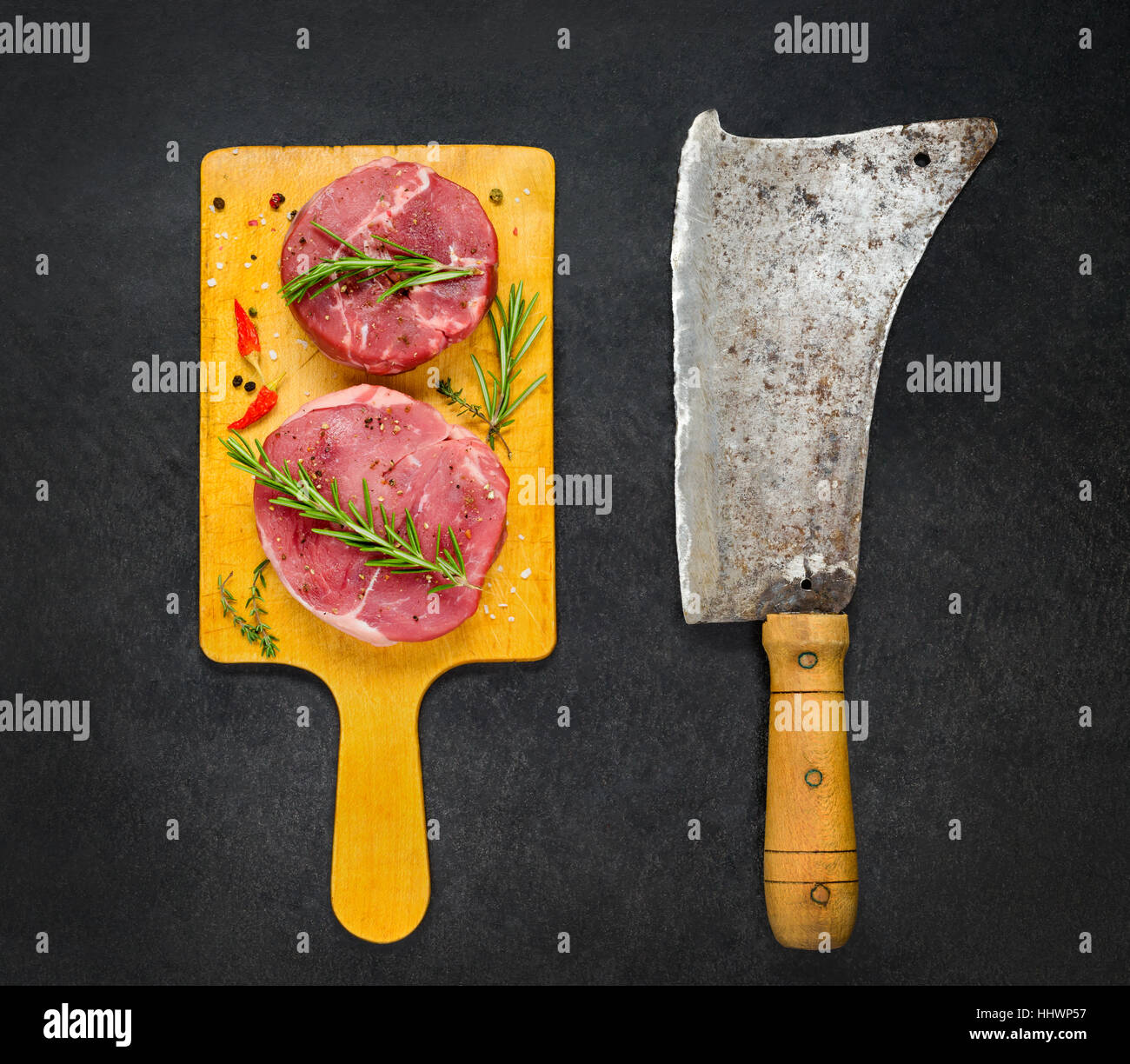 Top View of Raw Beef Chops condimented with Herbs and Spices on Wooden ...