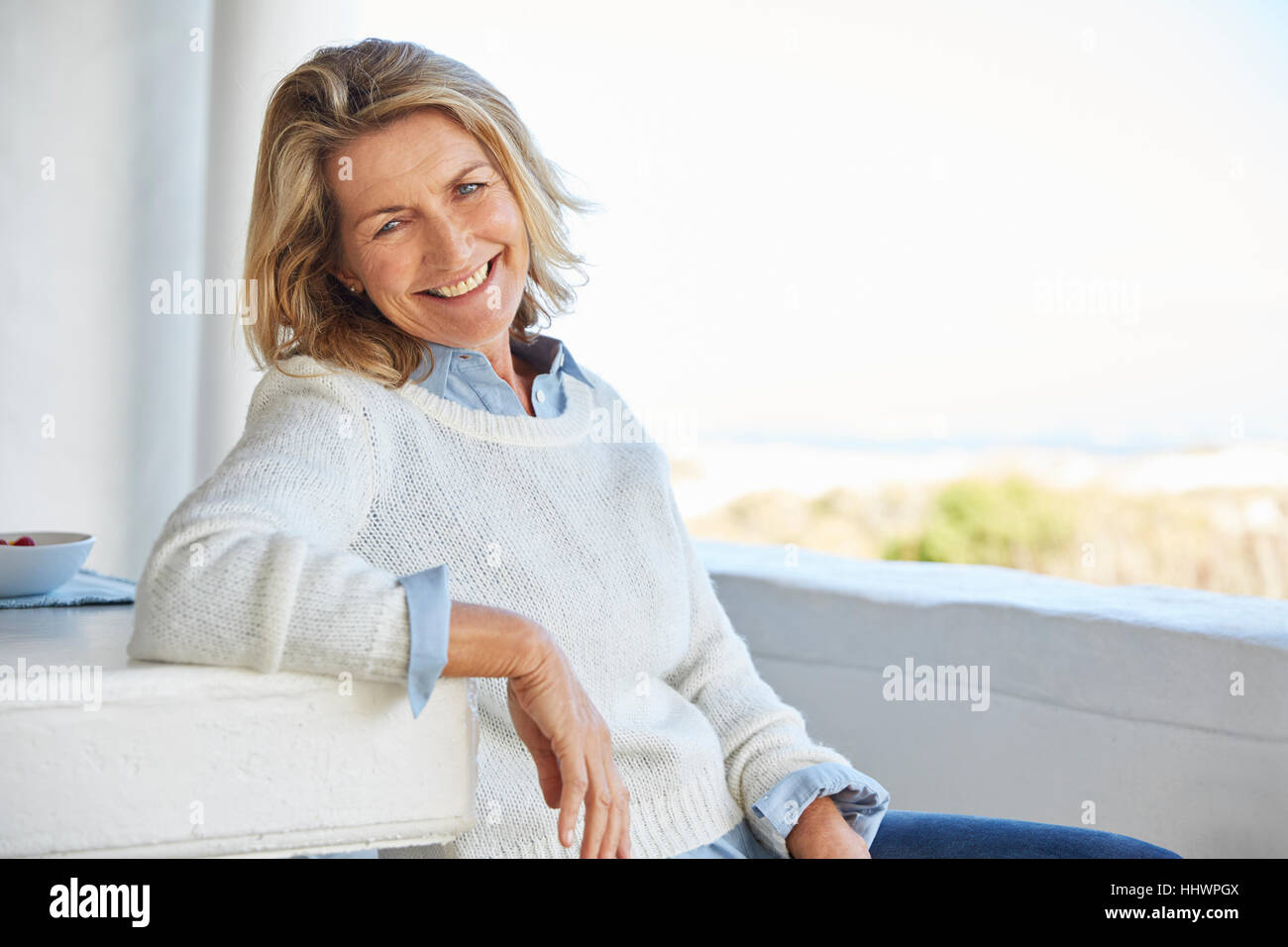 Portrait smiling senior woman on patio Stock Photo - Alamy