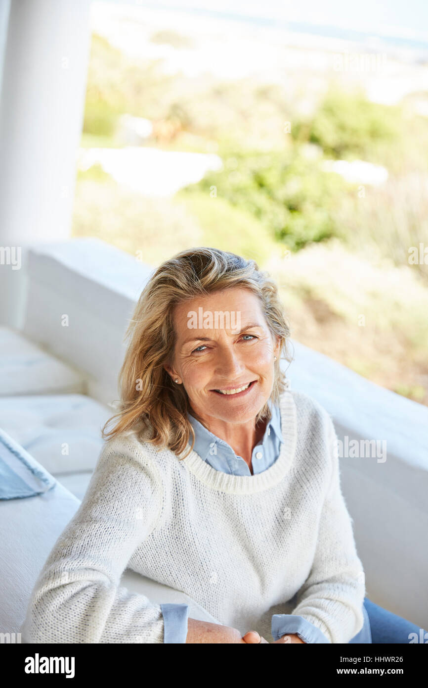Portrait smiling senior woman on patio Stock Photo - Alamy