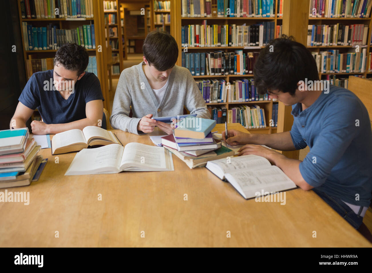 Male students doing research books hi-res stock photography and images ...