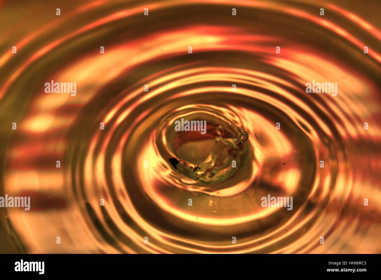 Orange water drop with waves on the surface. Difficult shot Stock Photo ...