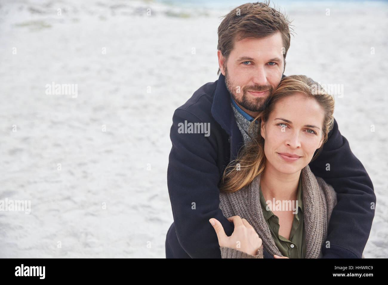 Portrait serene affectionate couple hugging on beach Stock Photo - Alamy