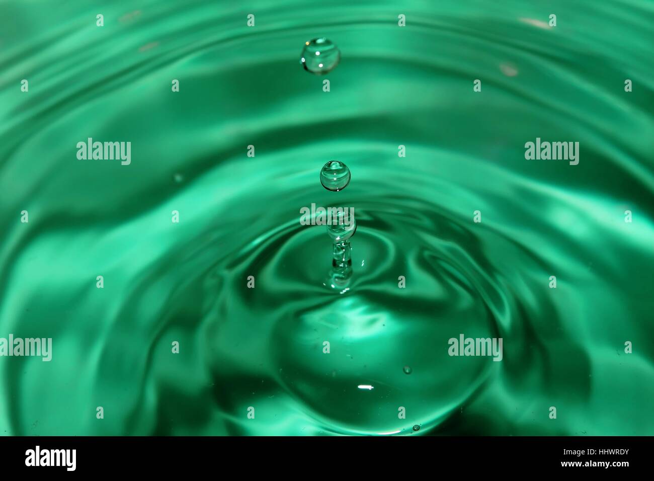 Green water drop with waves on the surface. Difficult shot Stock Photo ...