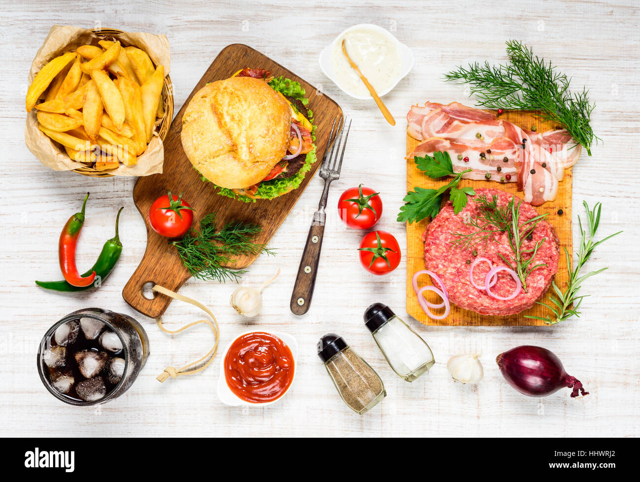 Fast Food Burger, Cold Cola and French Fries with Raw Ground Beef and ...