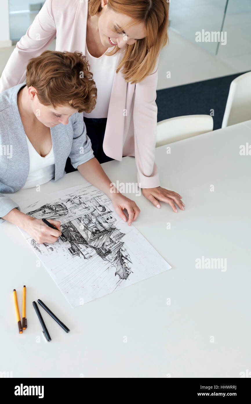 Female designers drawing sketch in conference room Stock Photo - Alamy