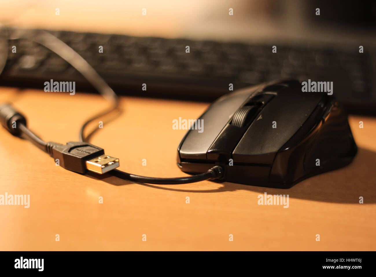 Unplugged black stylish gaming computer mouse lying on table Stock ...