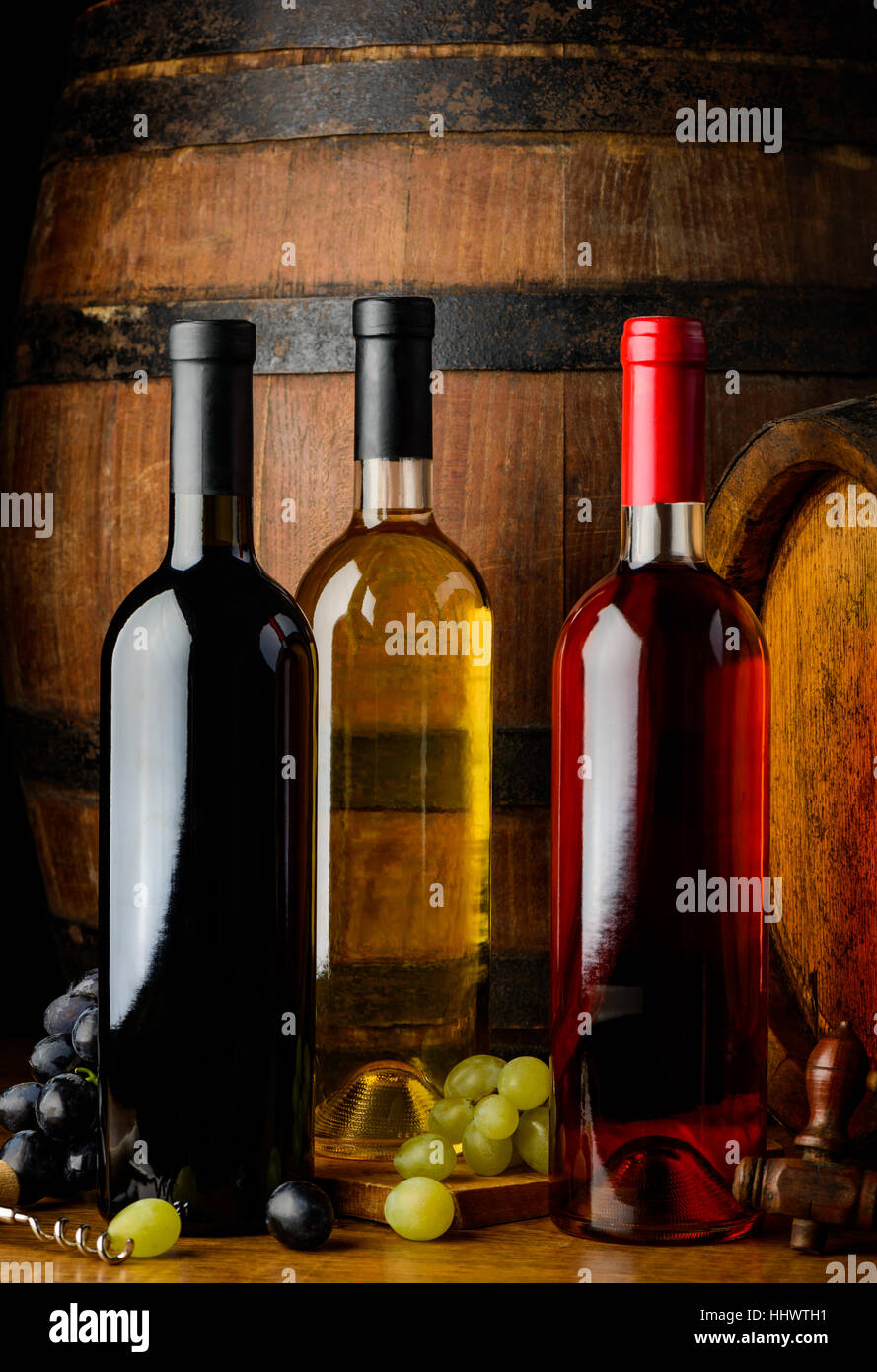 Tree bottles of wine in a vintage wine cellar. Red, white and rose wine ...
