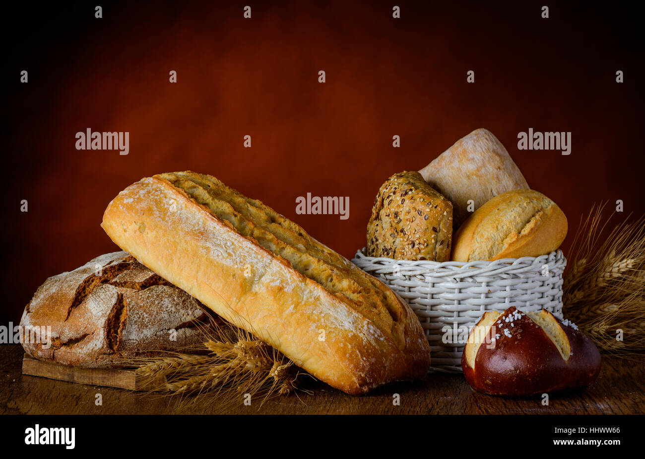 bread in traditional still life with bun basket and wheat Stock Photo ...
